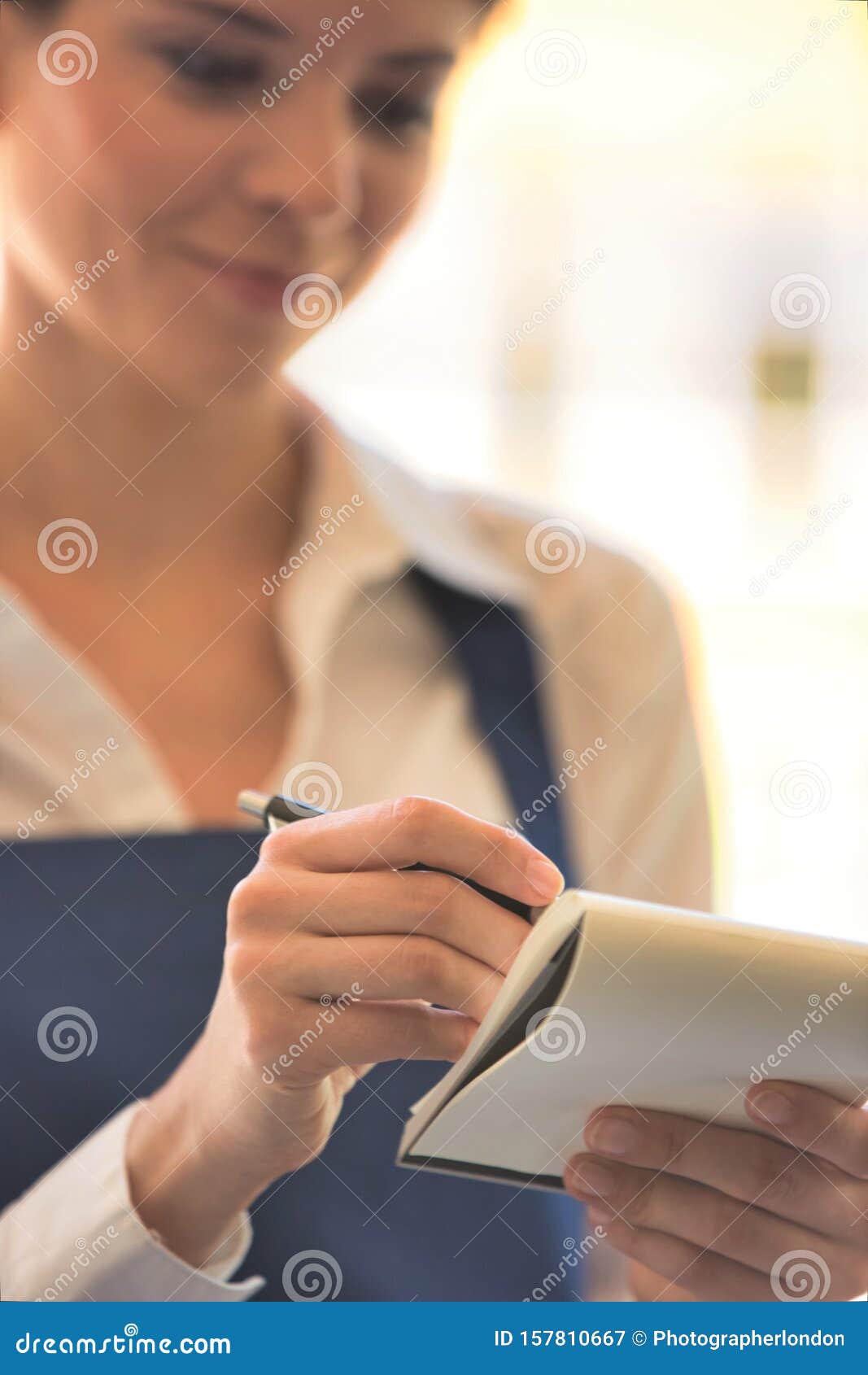 Midsection of Young Waitress Writing on Notepad at Restaurant Stock ...