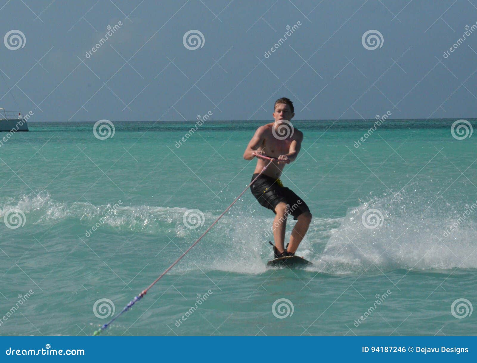 Young Wakeboarder in a Crouch in Aruban Waters Stock Photo - Image of ...