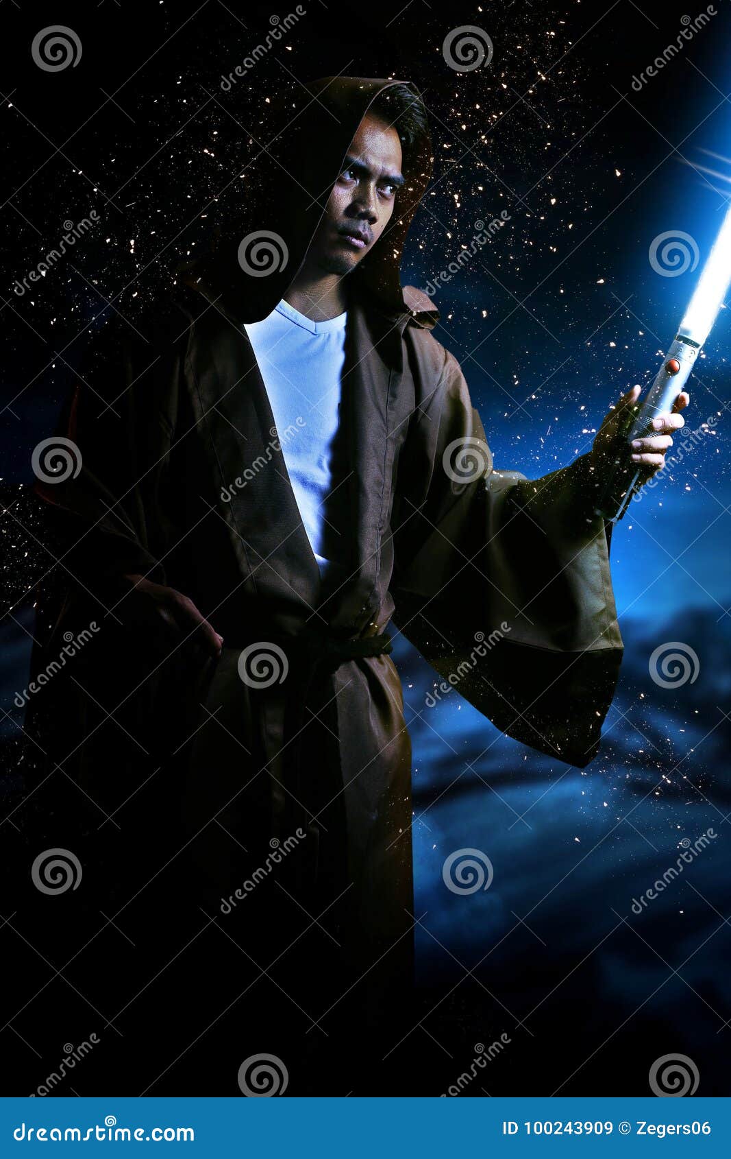 Young Warrior with Brown Hooded Cape Holding a Light Saber Stock Image ...