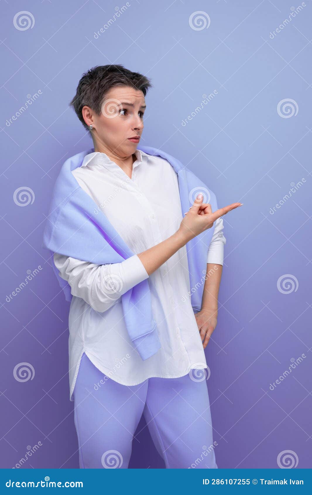 Young Well-groomed Indignant Lady Points Her Finger To the Side Stock ...