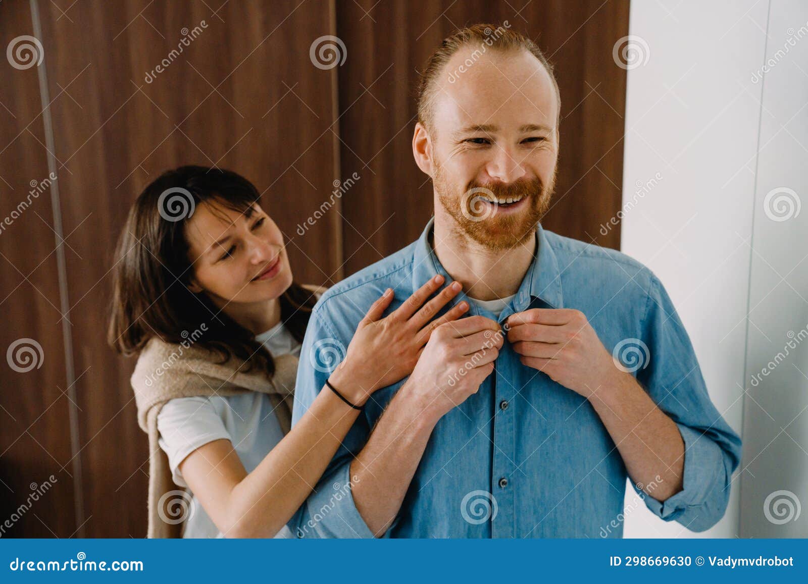 Young Couple Getting Dressed while Standing in Bedroom Together Stock ...