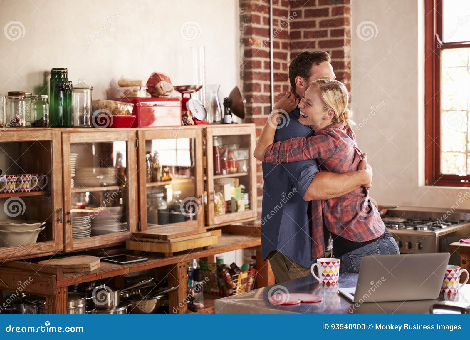 Young White Couple Hugging in Their Kitchen Stock Photo - Image of ...