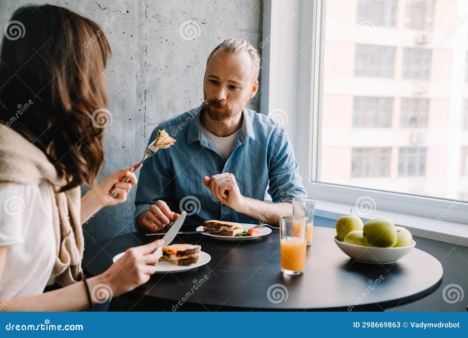 Young Couple Sitting by Table while Having Breakfast at Home Stock ...