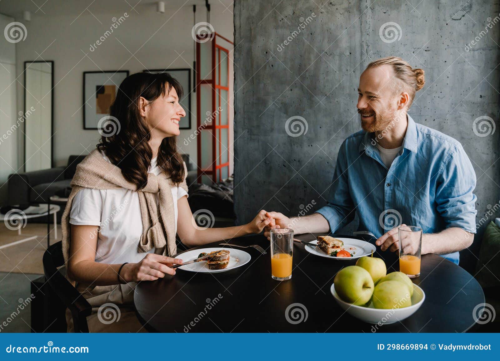Young Couple Sitting by Table while Having Breakfast at Home Stock ...
