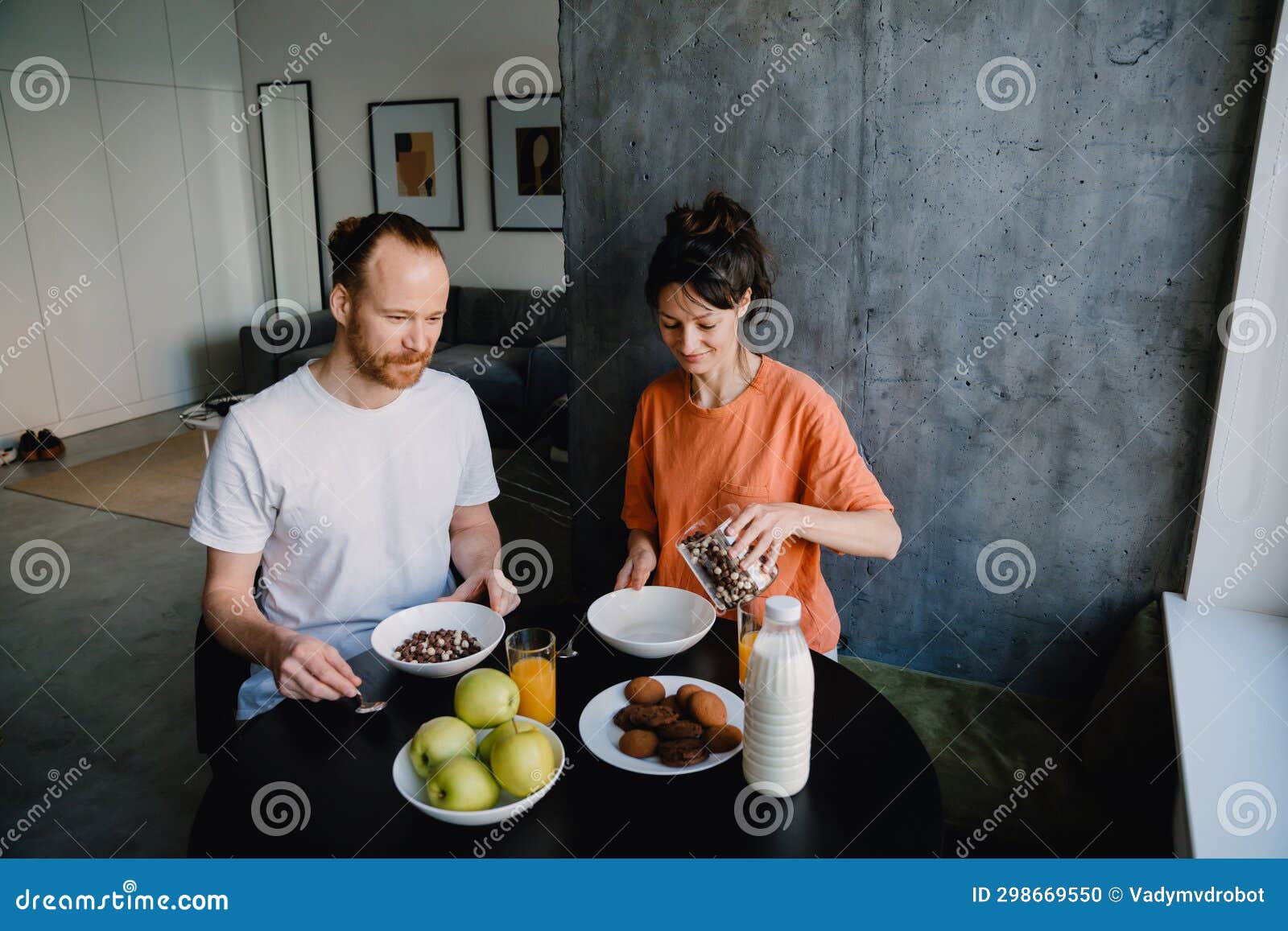 Young Couple Smiling while Having Breakfast Together at Home Stock ...