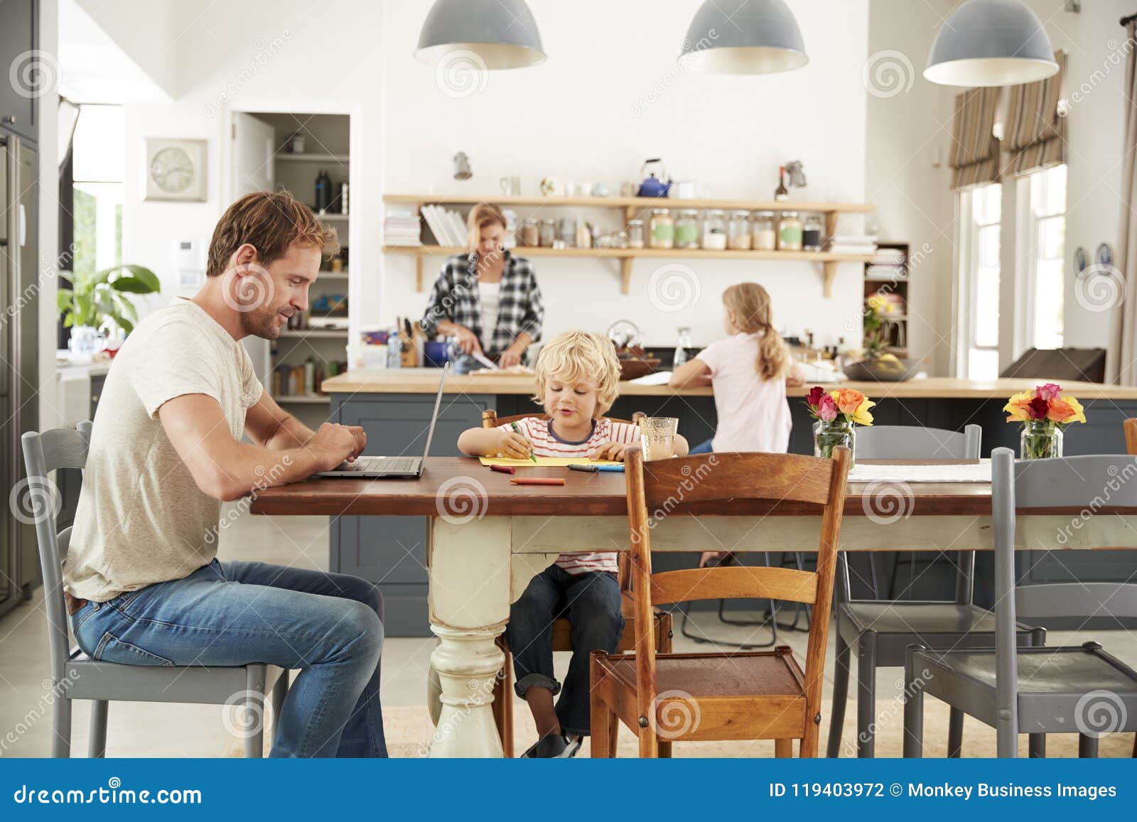 Young White Family Busy Working in Their Kitchen Stock Photo - Image of ...