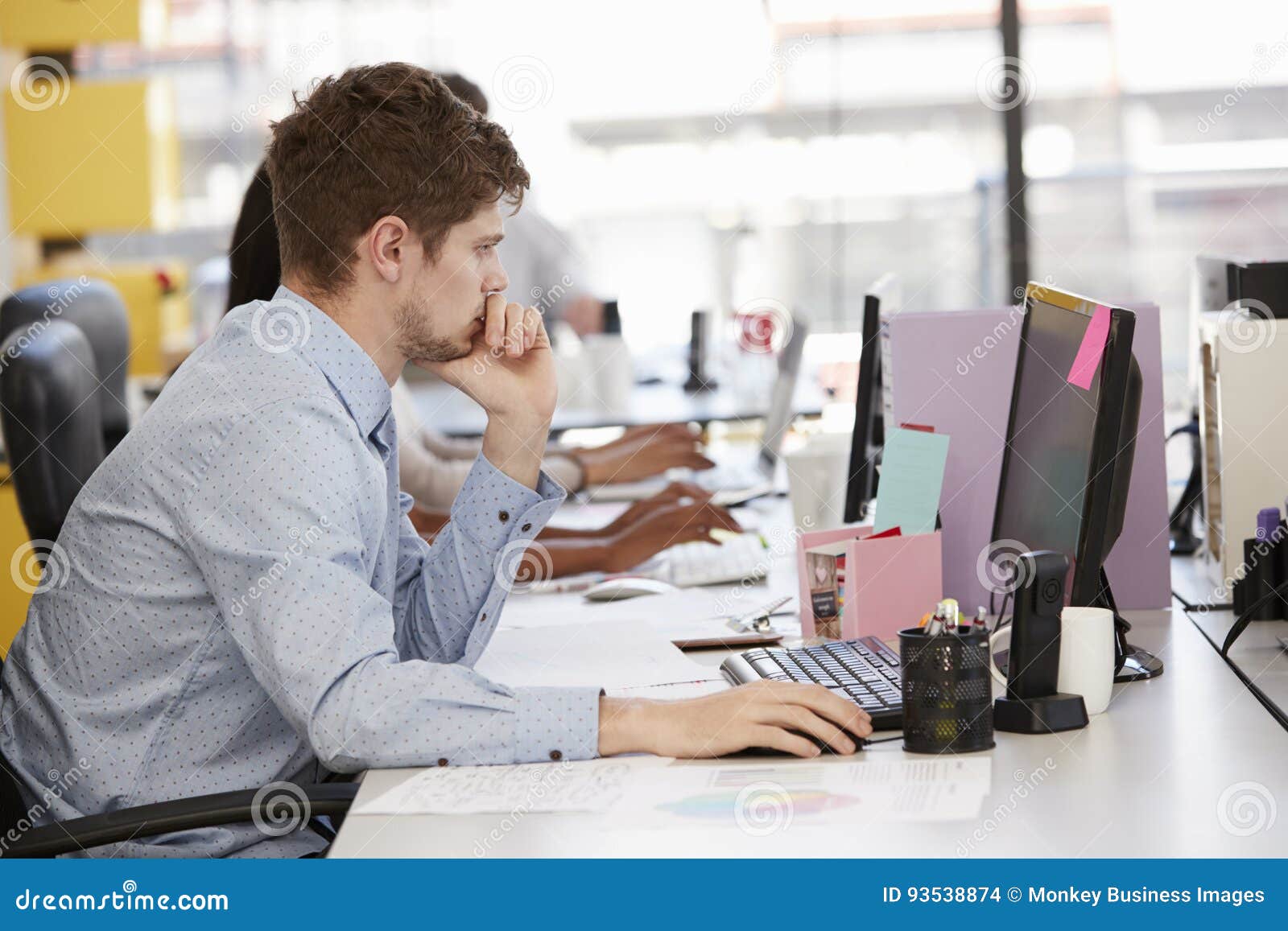 Young White Man Working at Computer in Open Plan Office Stock Photo ...