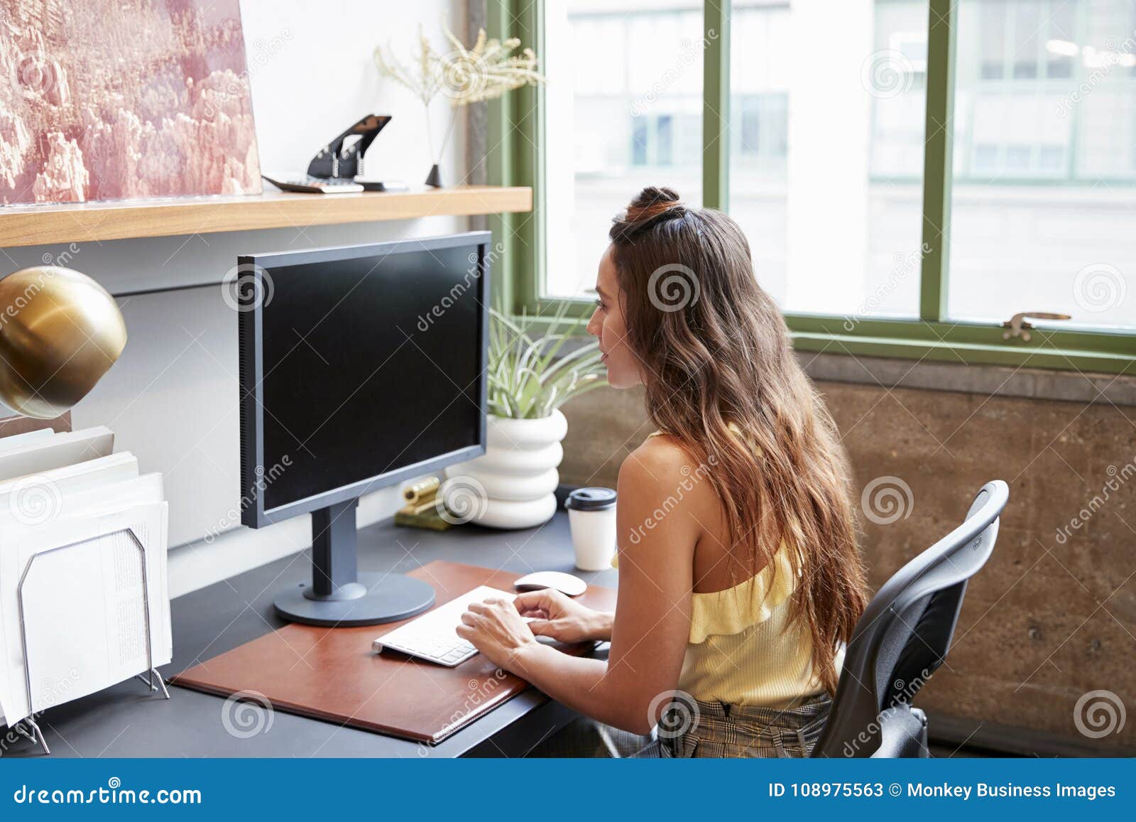 Young White Woman Using a Computer in an Office, Back View Stock Image ...