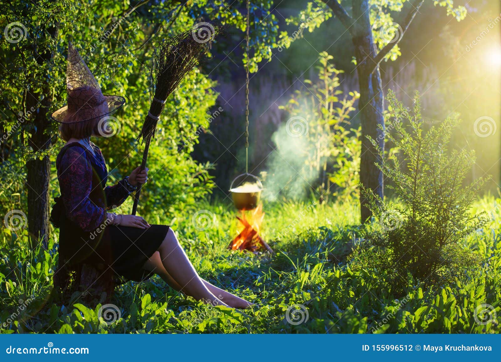 Witch by Fire in Magic Forest Makes in Cauldron Magic Potion Stock ...