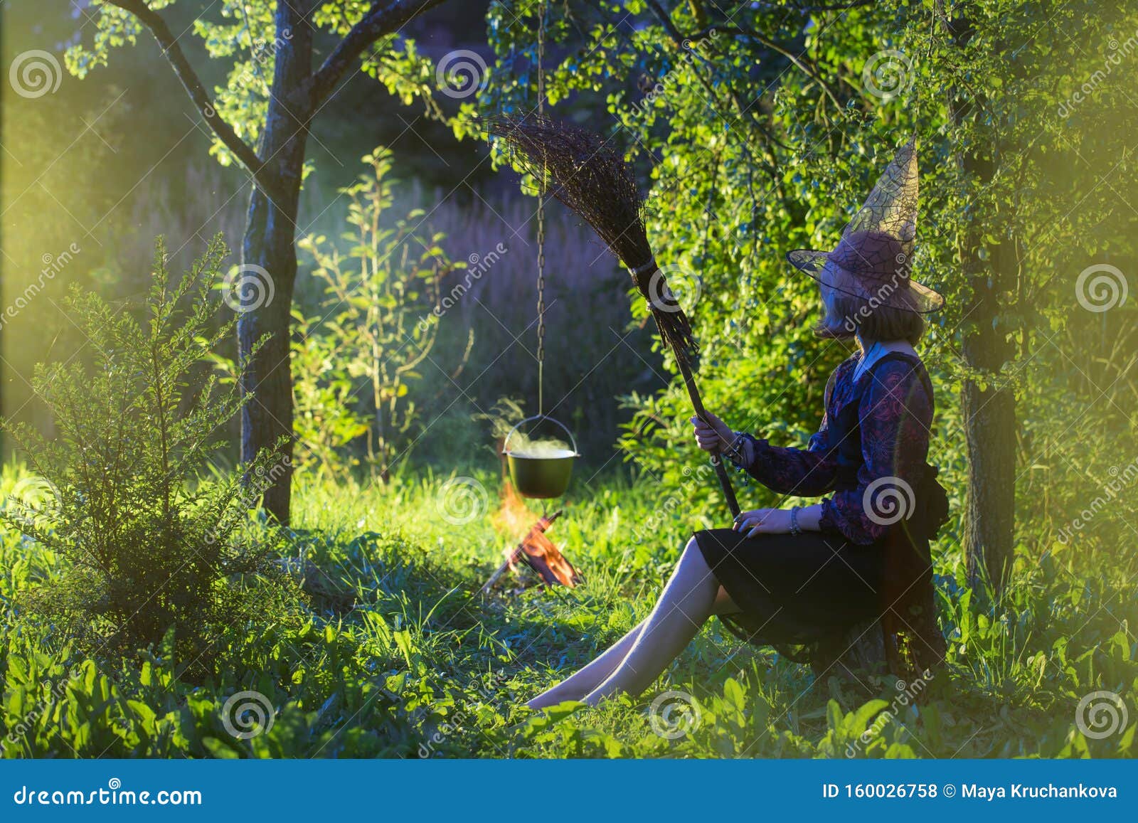 Young Witch by Fire in Magic Forest Makes in Cauldron Magic Potion ...