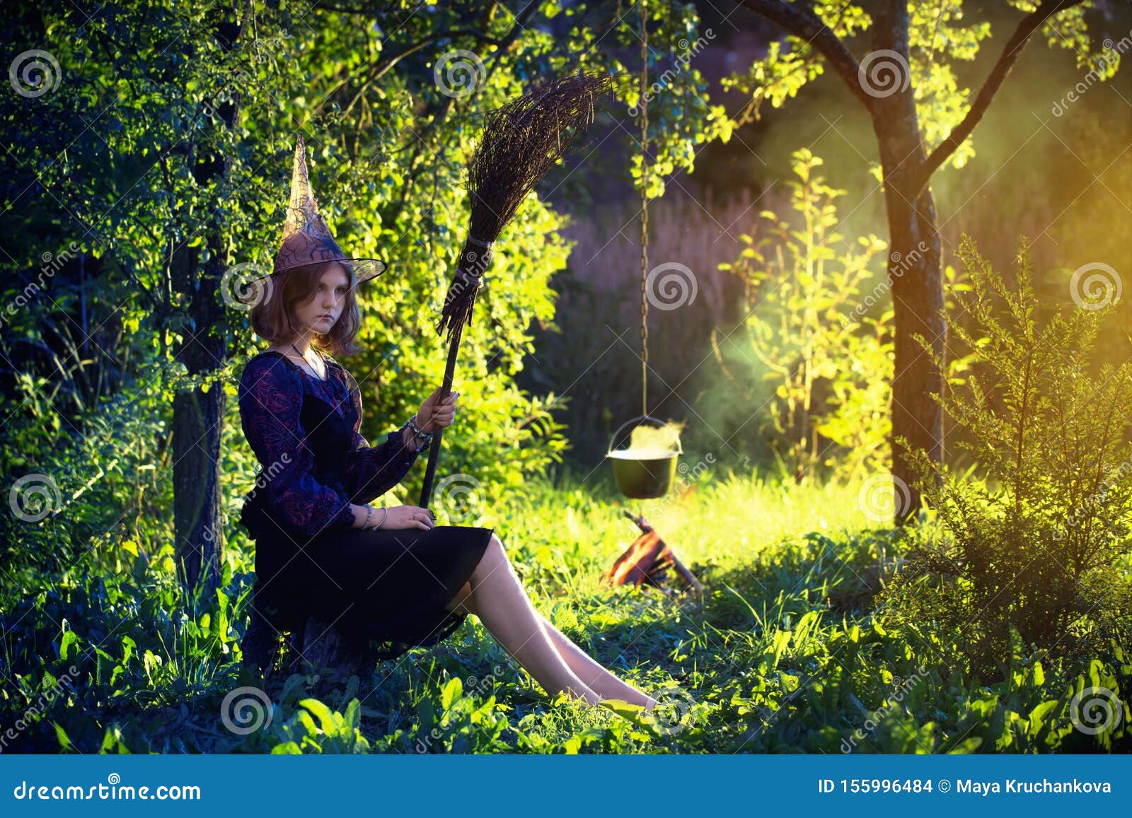 Young Witch by Fire in Magic Forest Makes Magic Potion Stock Photo ...