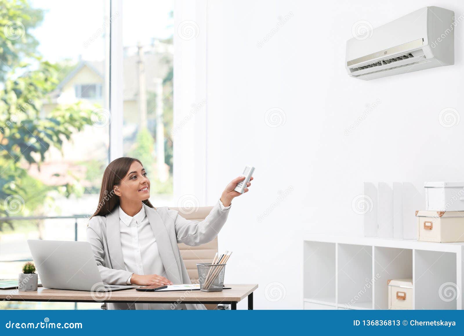 Young Woman with Air Conditioner Remote in Office Stock Image - Image ...