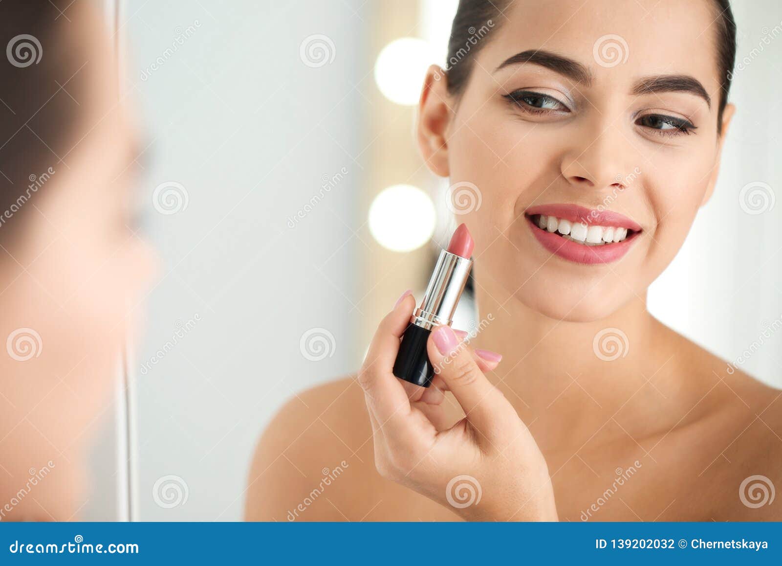 Young Woman Applying Lipstick in Front Stock Photo - Image of ...