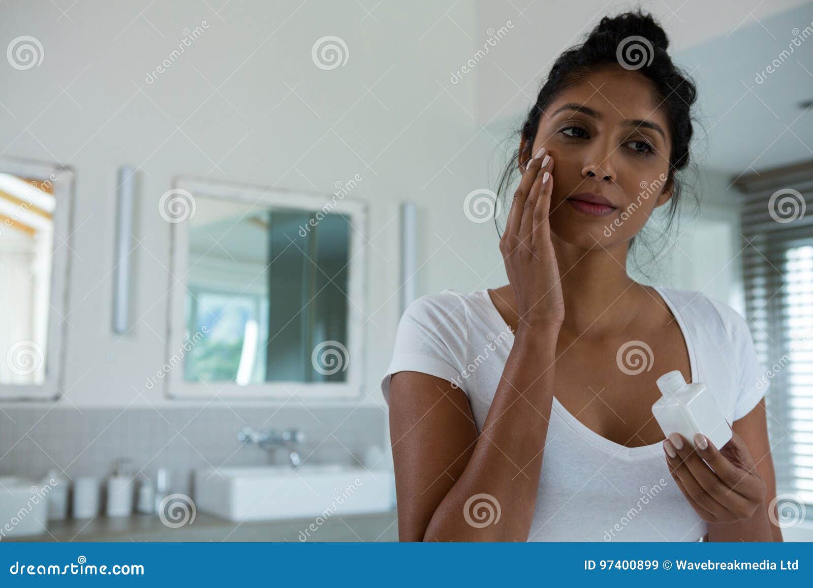 Young Woman Applying Lotion in Bathroom Stock Image - Image of head ...