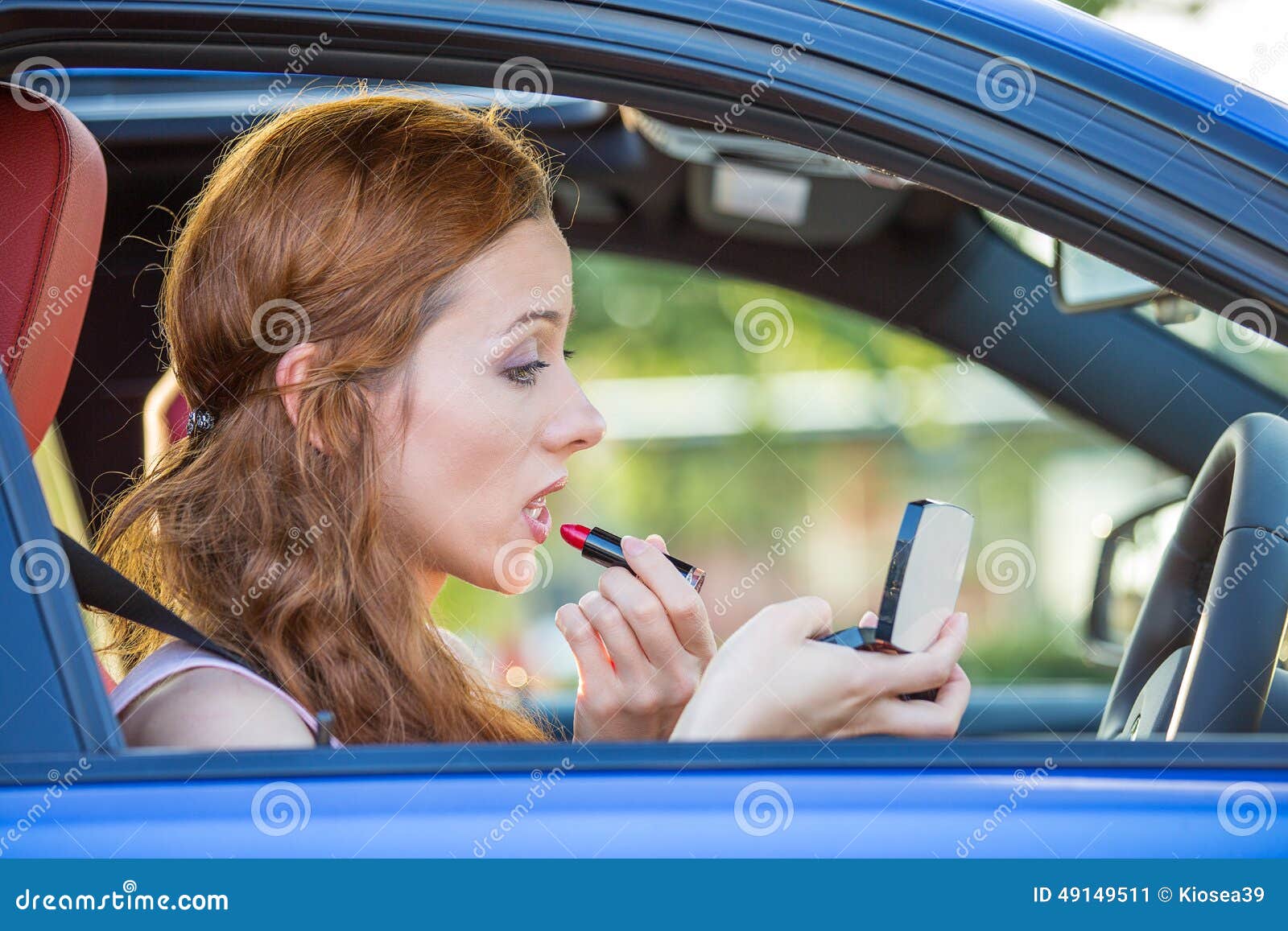 Young Woman Applying Makeup while Driving Car Stock Image - Image of ...