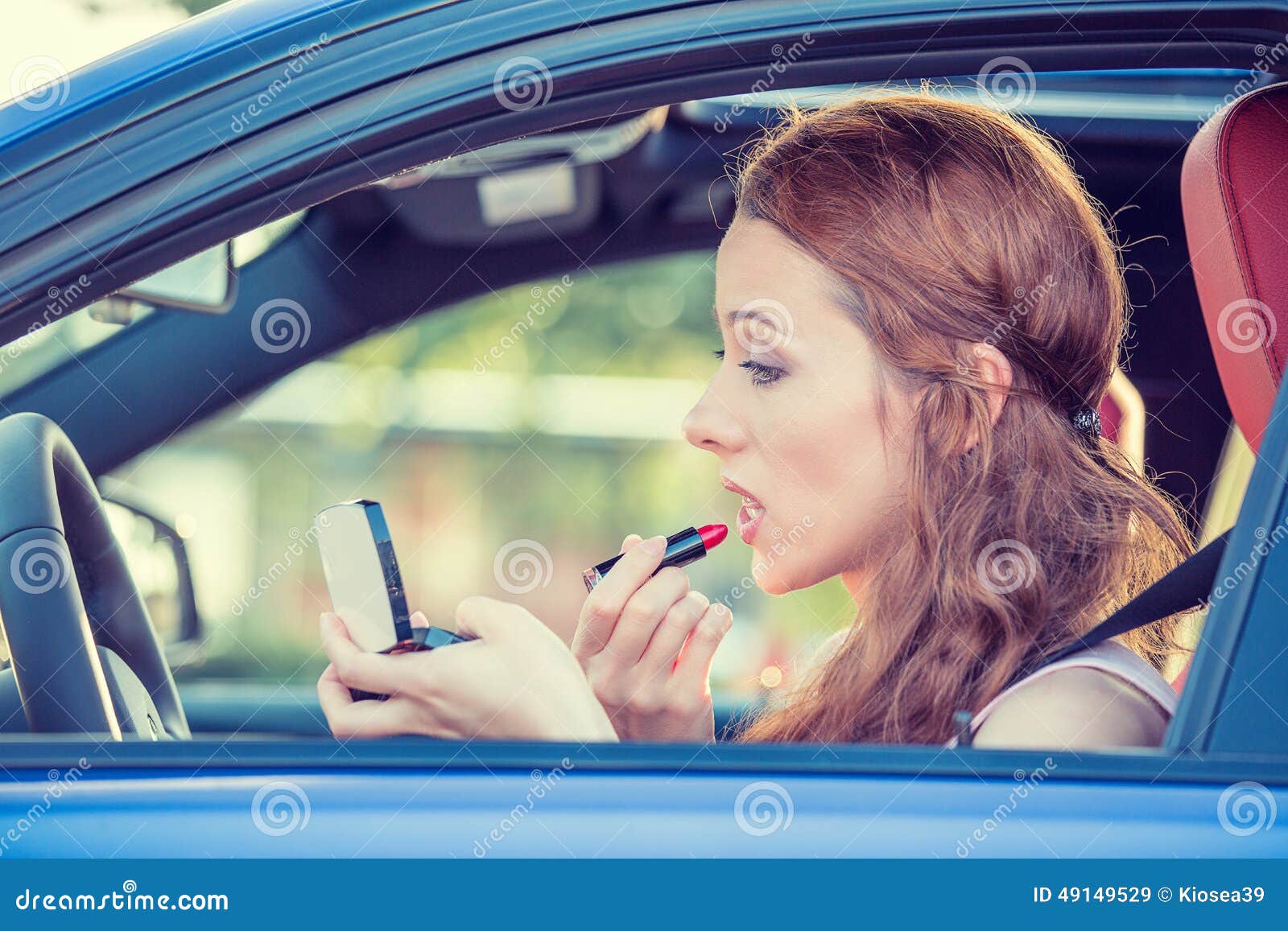 Young Woman Applying Makeup while Driving Car Stock Image - Image of ...