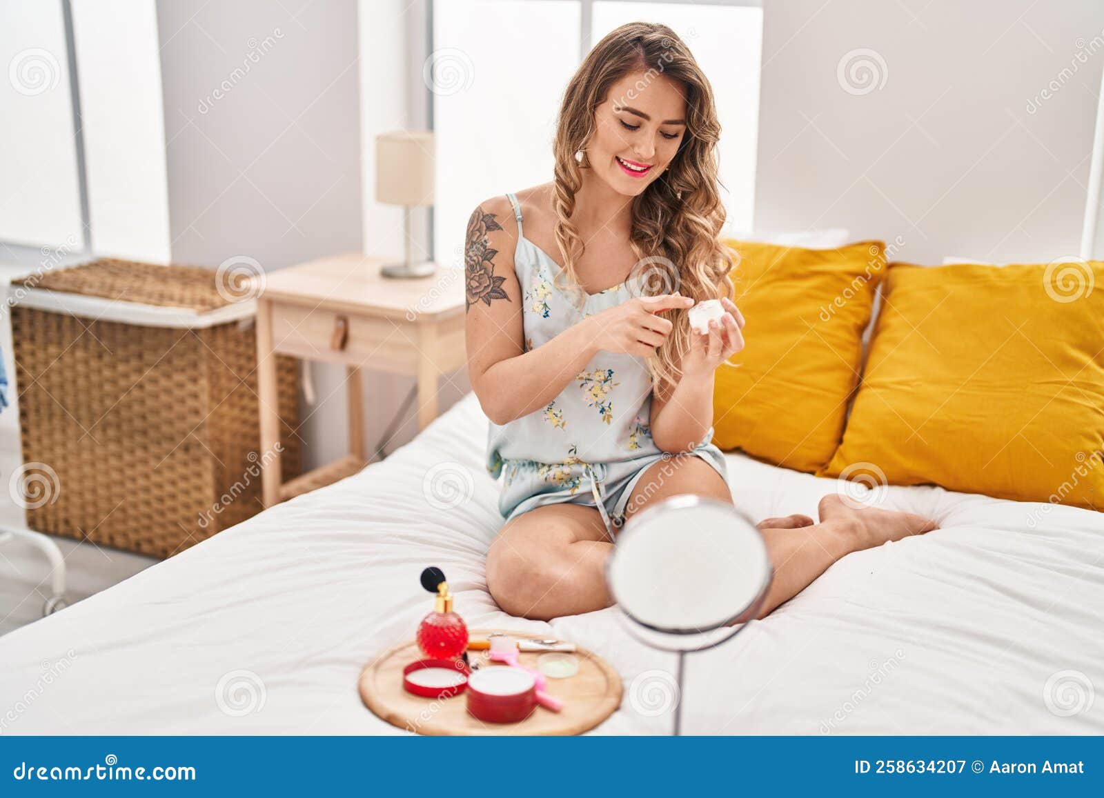 Young Woman Applying Makeup Sitting on Bed at Bedroom Stock Image ...