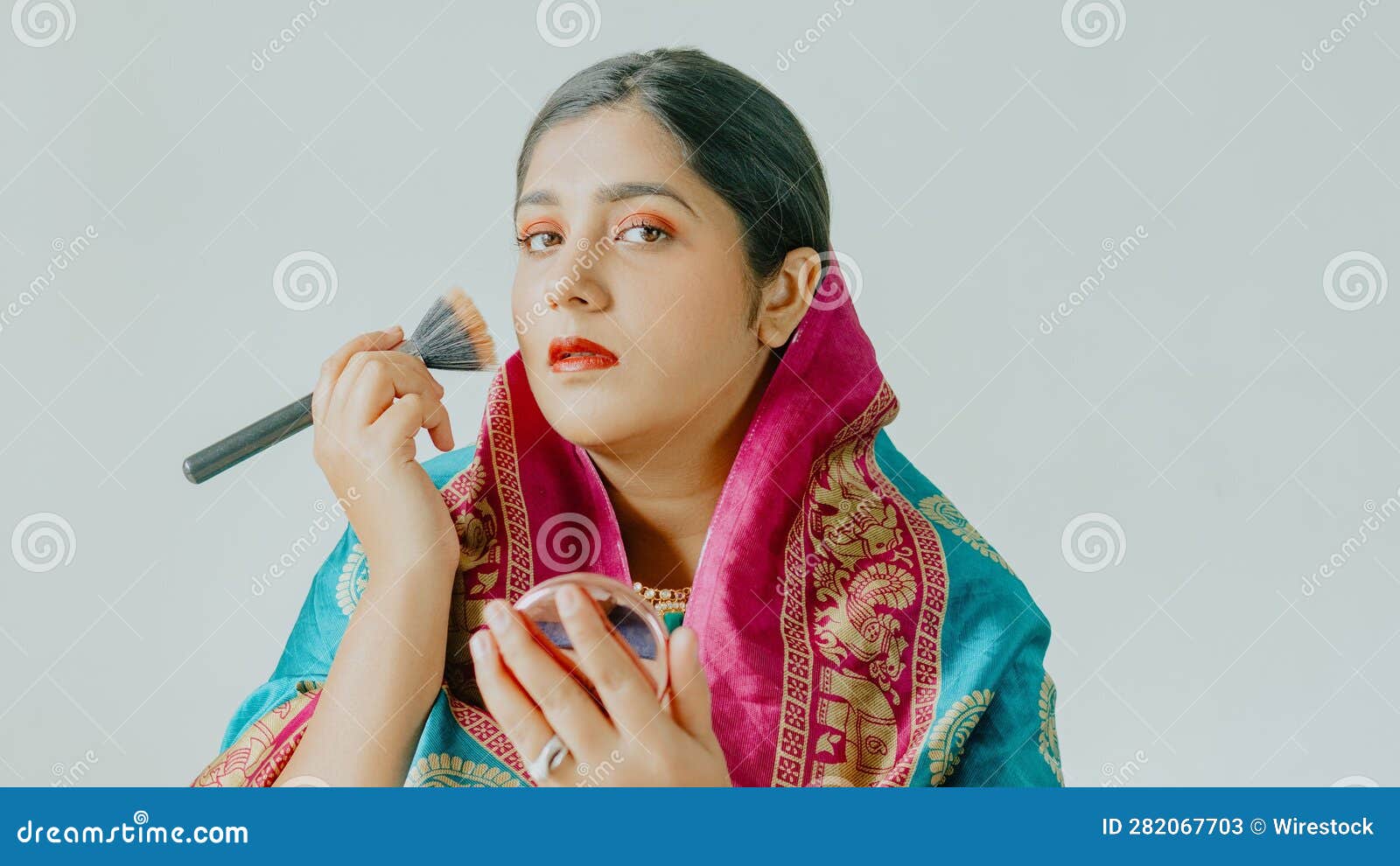 Young Woman Brushing Makeup with a Brush in Front of Her Face Stock ...