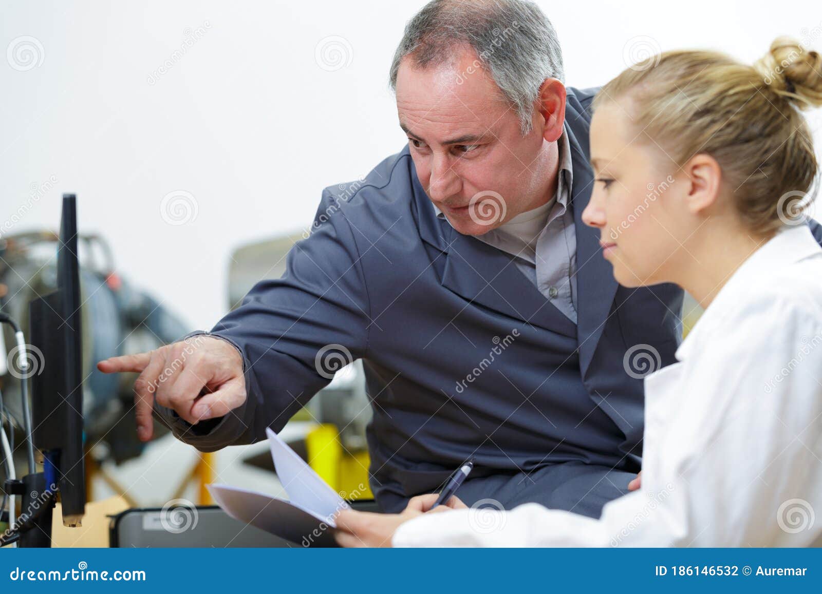 Young Woman As Apprentice Working on Laptop in Office Stock Photo ...