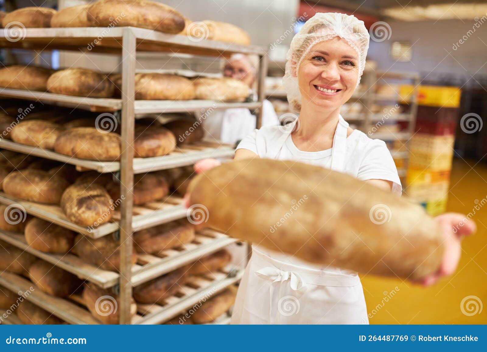 Young Woman As a Baker`s Apprentice with Ready-baked Bread Stock Image ...