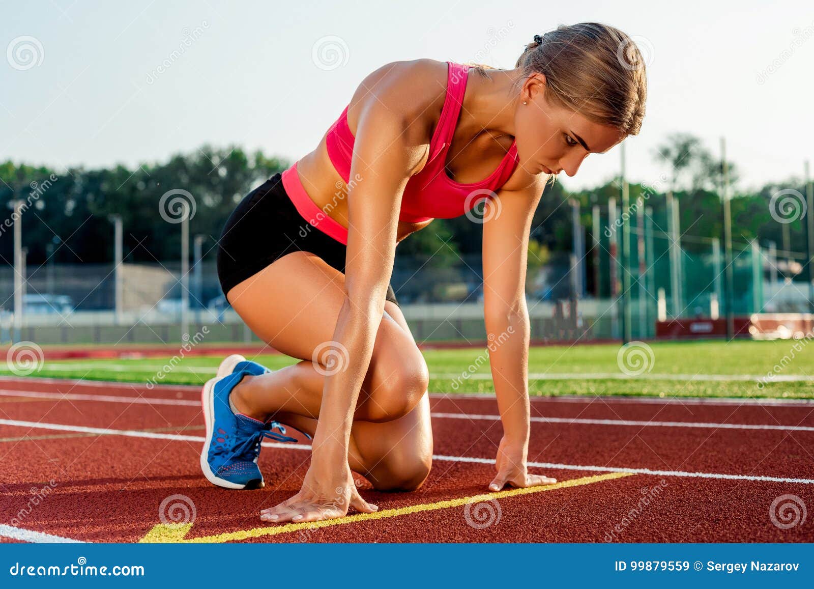 Young Woman Athlete At Starting Position Ready To Start A Race On