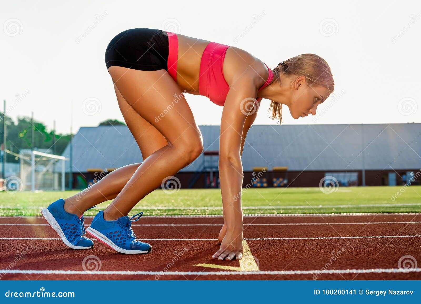 Young Woman Athlete At Starting Position Ready To Start A Race On