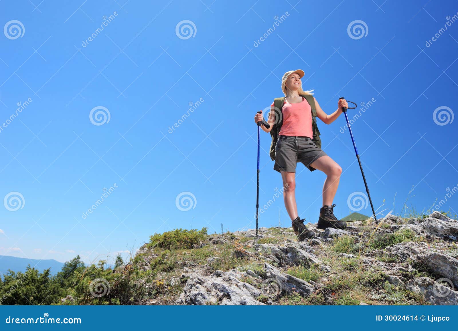 A Young Woman with Backpack and Hiking Poles Posing Stock Photo - Image ...