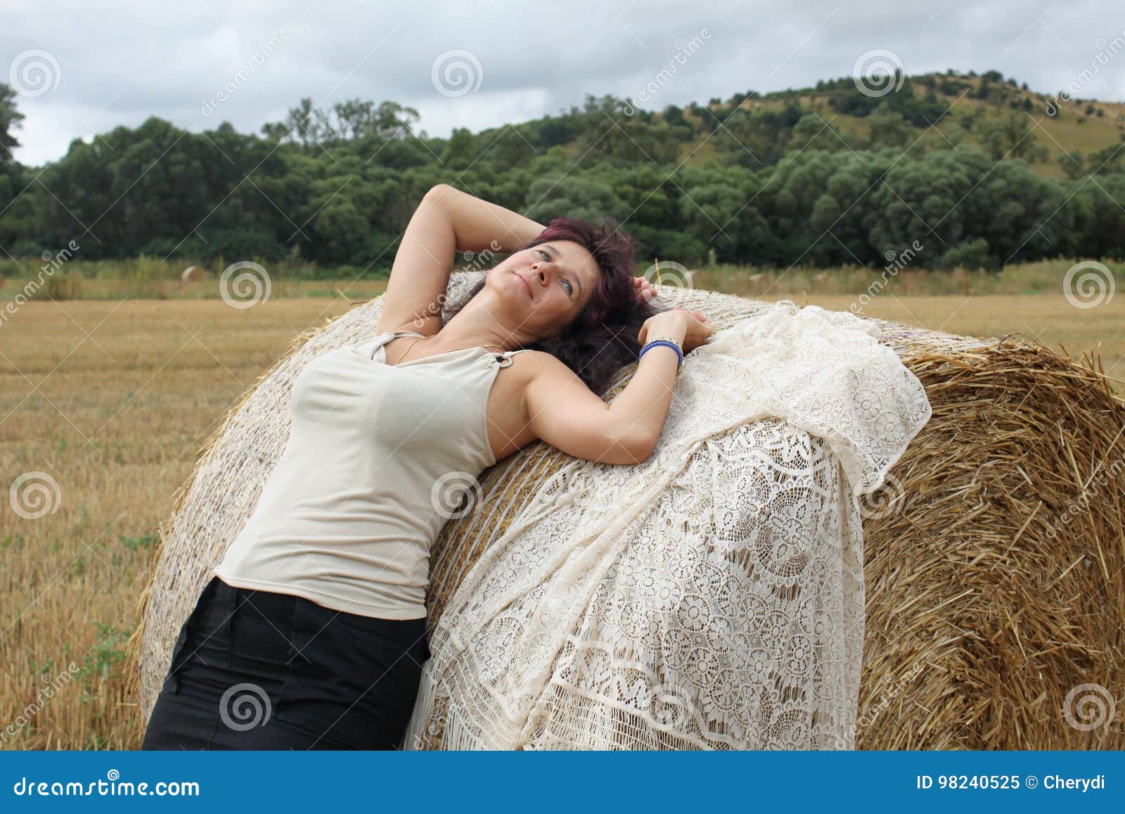 A Young Woman on a Bale of Hay Stock Image - Image of girl, happy: 98240525