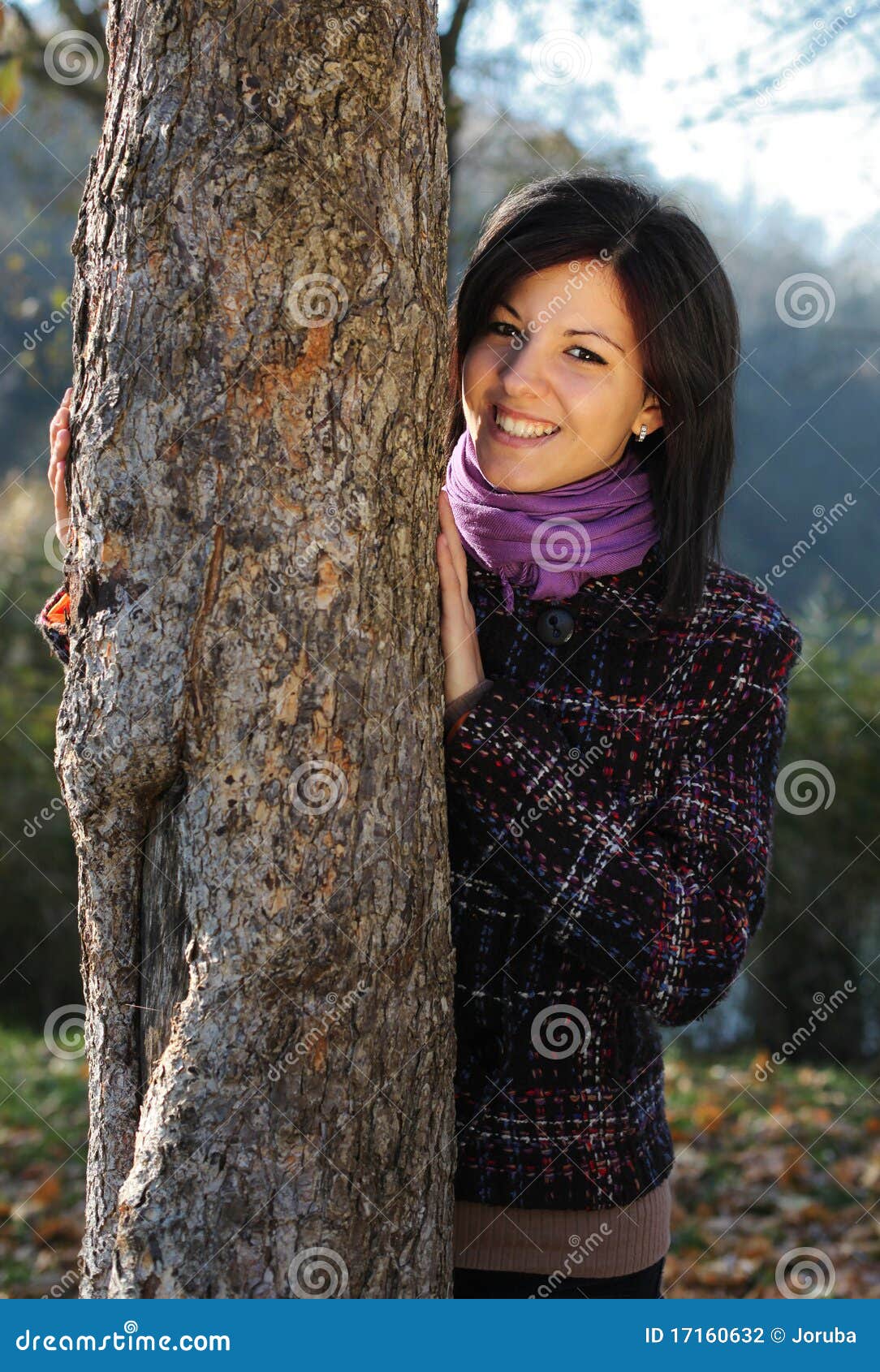 Young woman behind a tree stock photo. Image of happy - 17160632