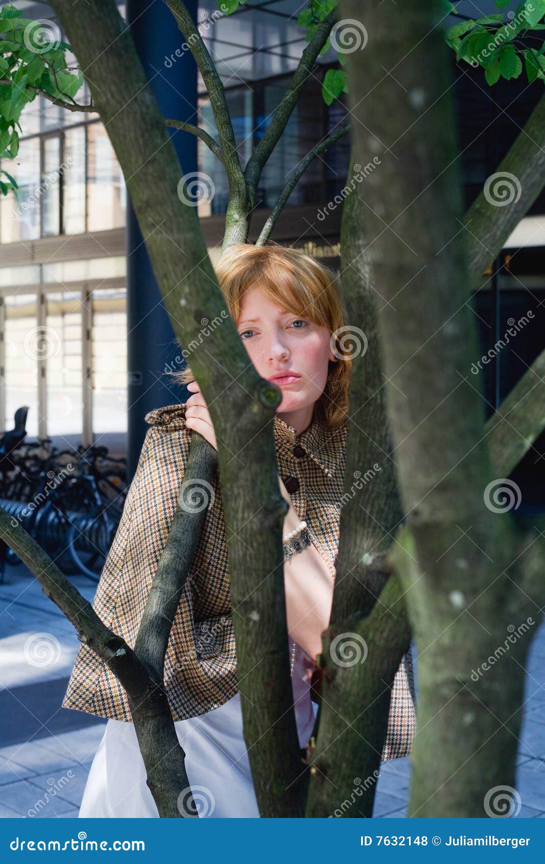 Young woman behind a tree stock photo. Image of outdoors - 7632148