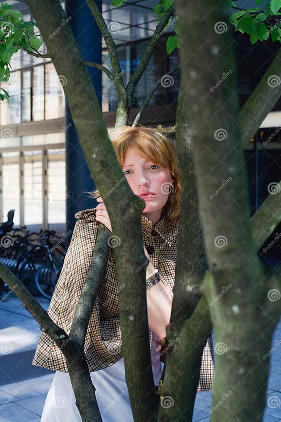Young woman behind a tree stock photo. Image of outdoors - 7632148