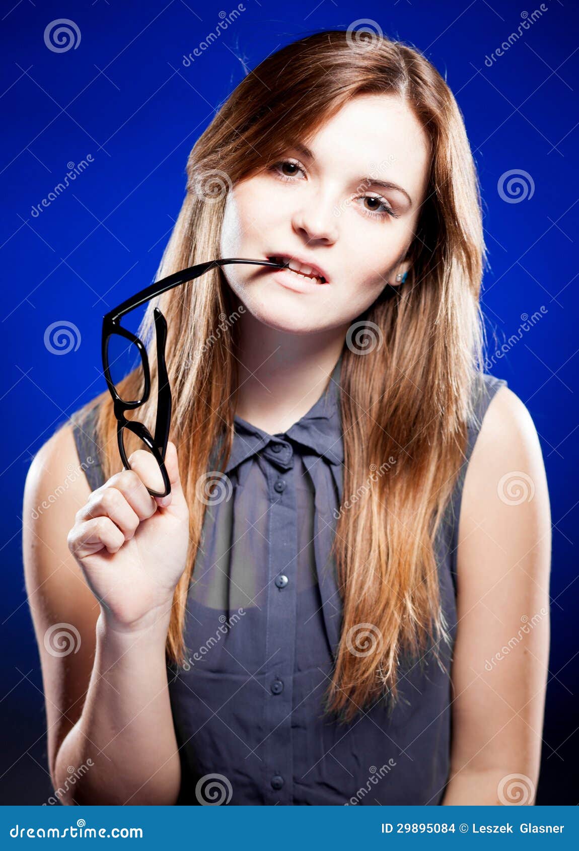 Young Woman Biting a Nerd Glasses with Interested Look Stock Photo ...