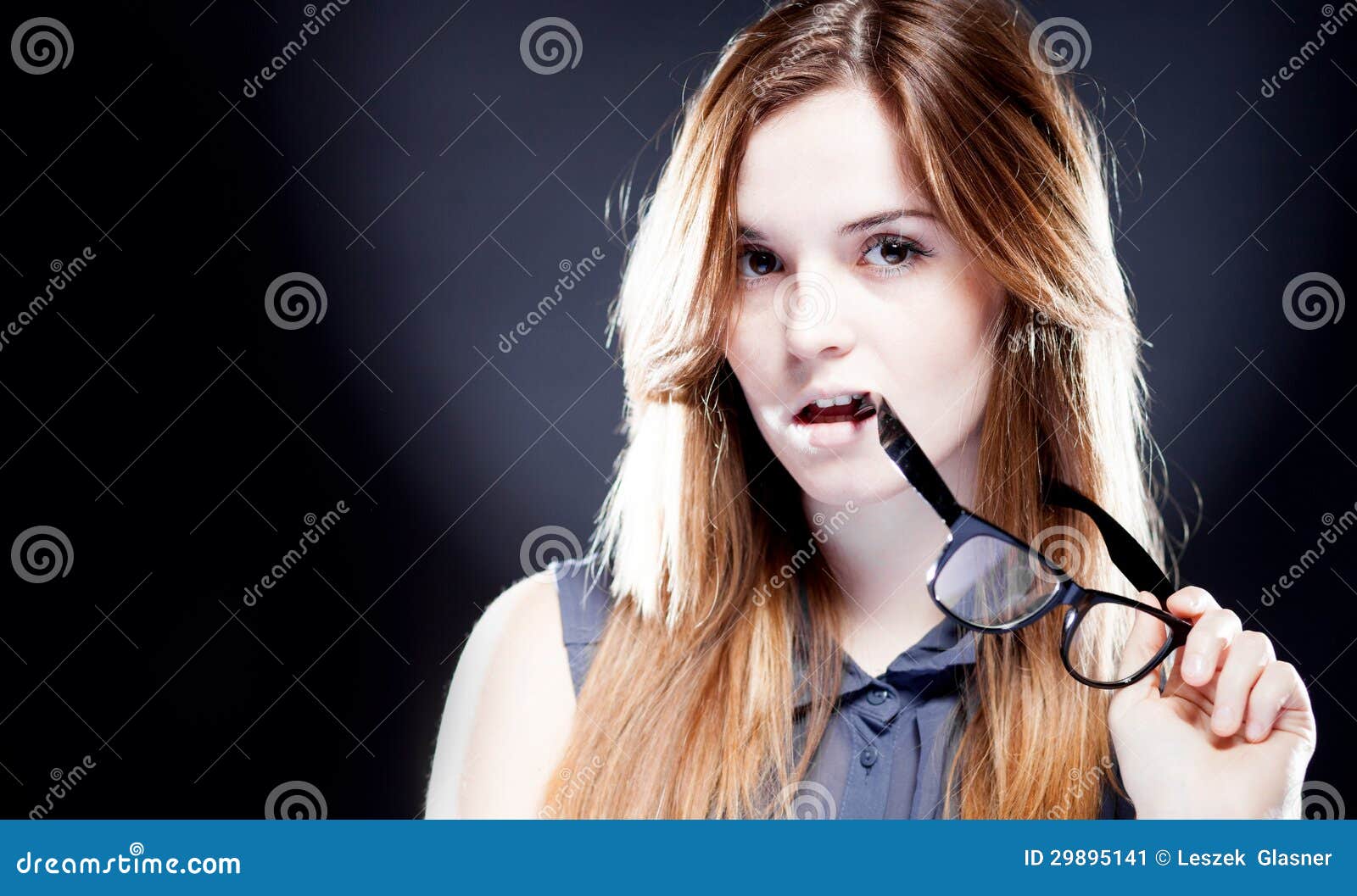 Young Woman Biting a Nerd Glasses with Interested Look Stock Image ...