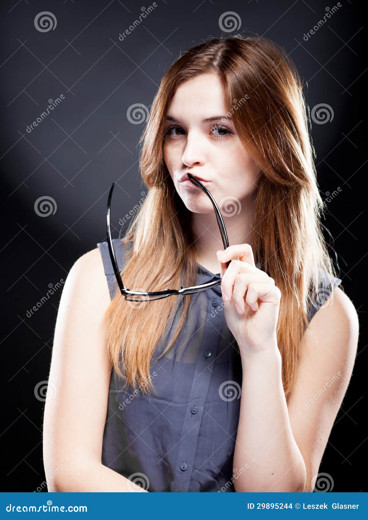 Young Woman Biting a Nerd Glasses with Interested Look Stock Photo ...