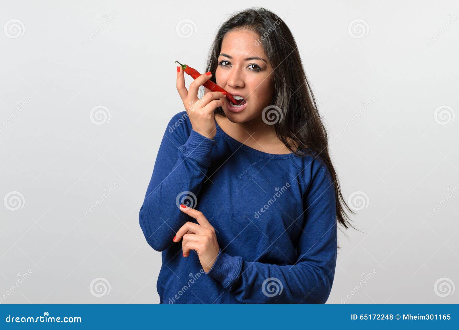 Young Woman Biting on Red Chili Pepper Stock Photo - Image of ...
