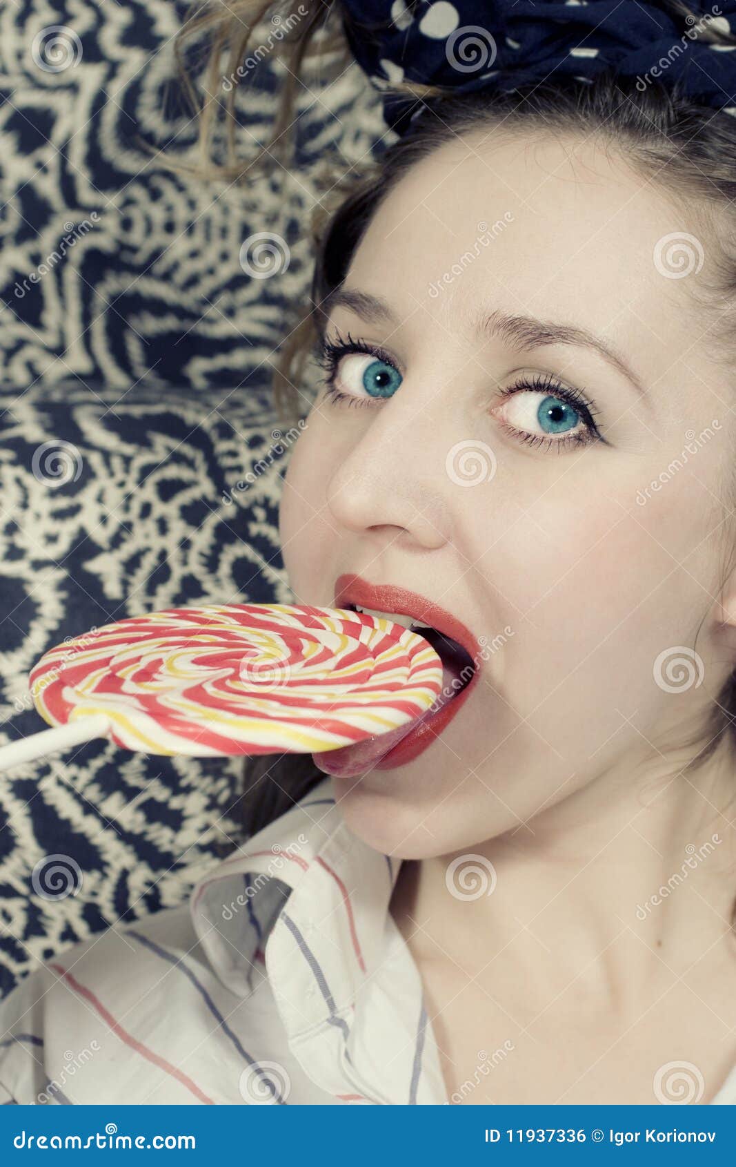 Young Woman Biting Sugar Candy Stock Photo - Image of beads, shirt ...