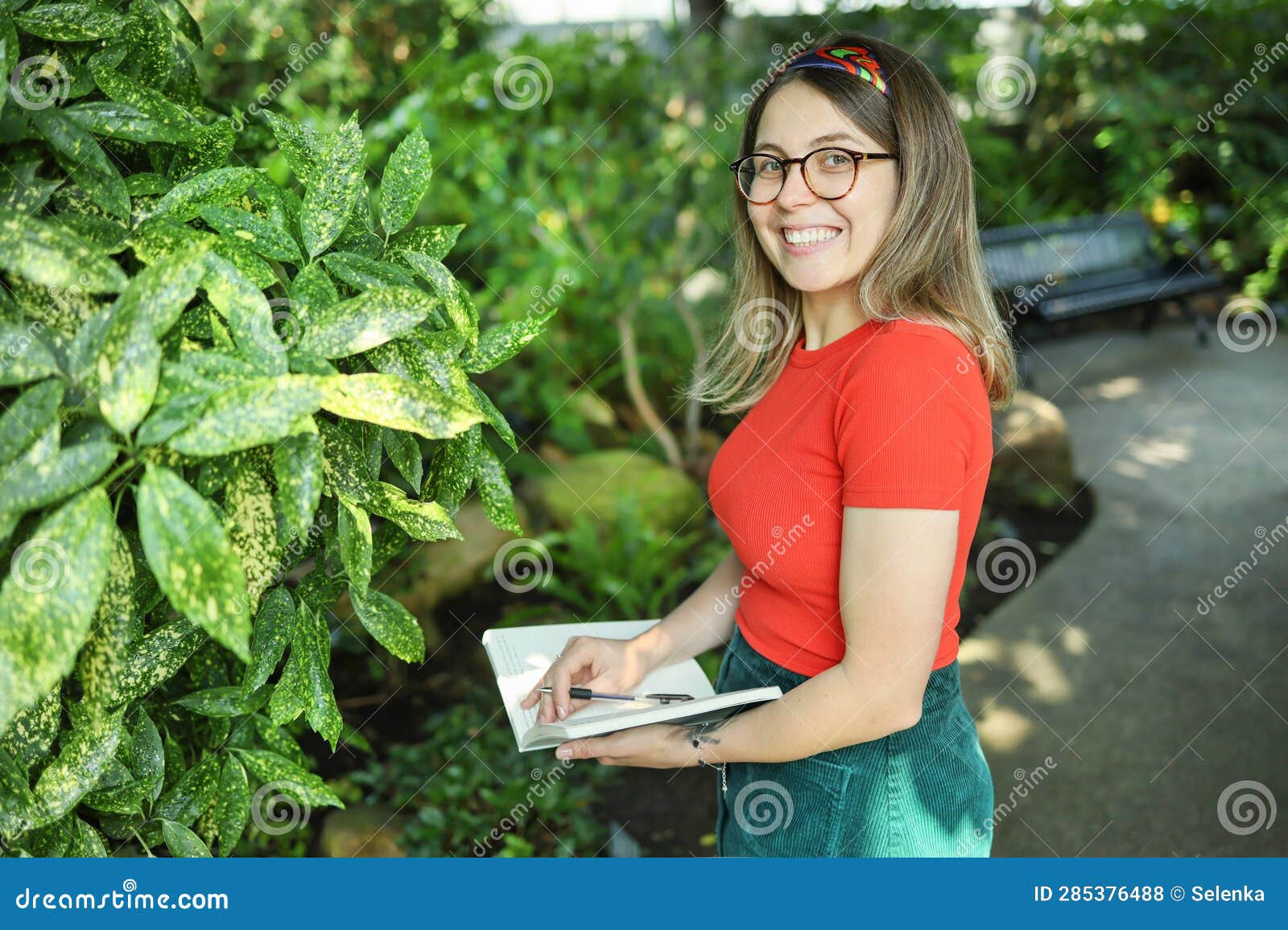 Woman Botanist Dressed In Safari Style In Greenhouse. Naturalist With ...