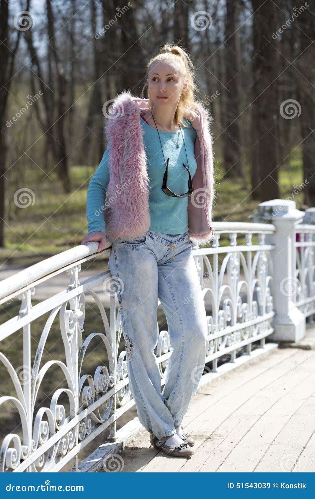 The Young Woman in Bright Clothes on the Bridge in Park in the Early ...