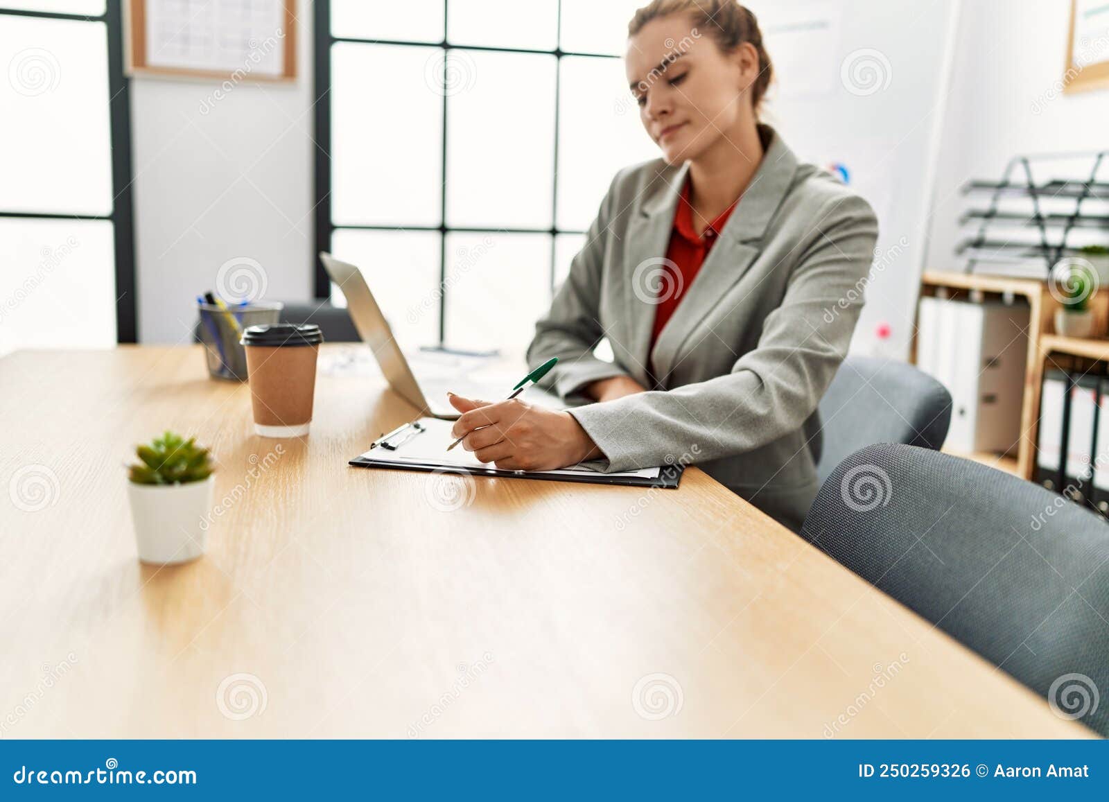 Young Woman Business Worker Writing on Checklist Working at Office ...