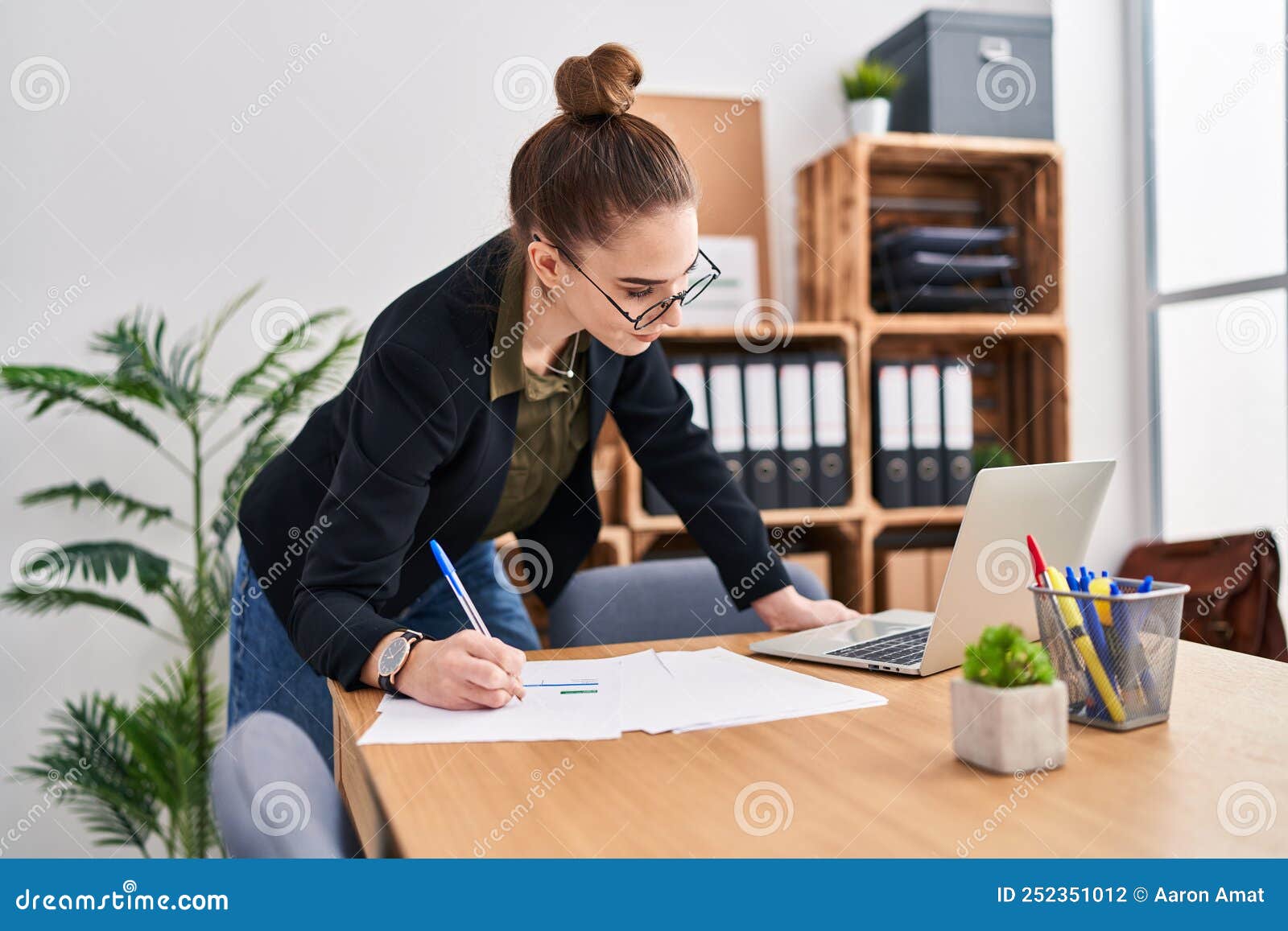 Young Woman Business Worker Writing on Document at Office Stock Photo ...