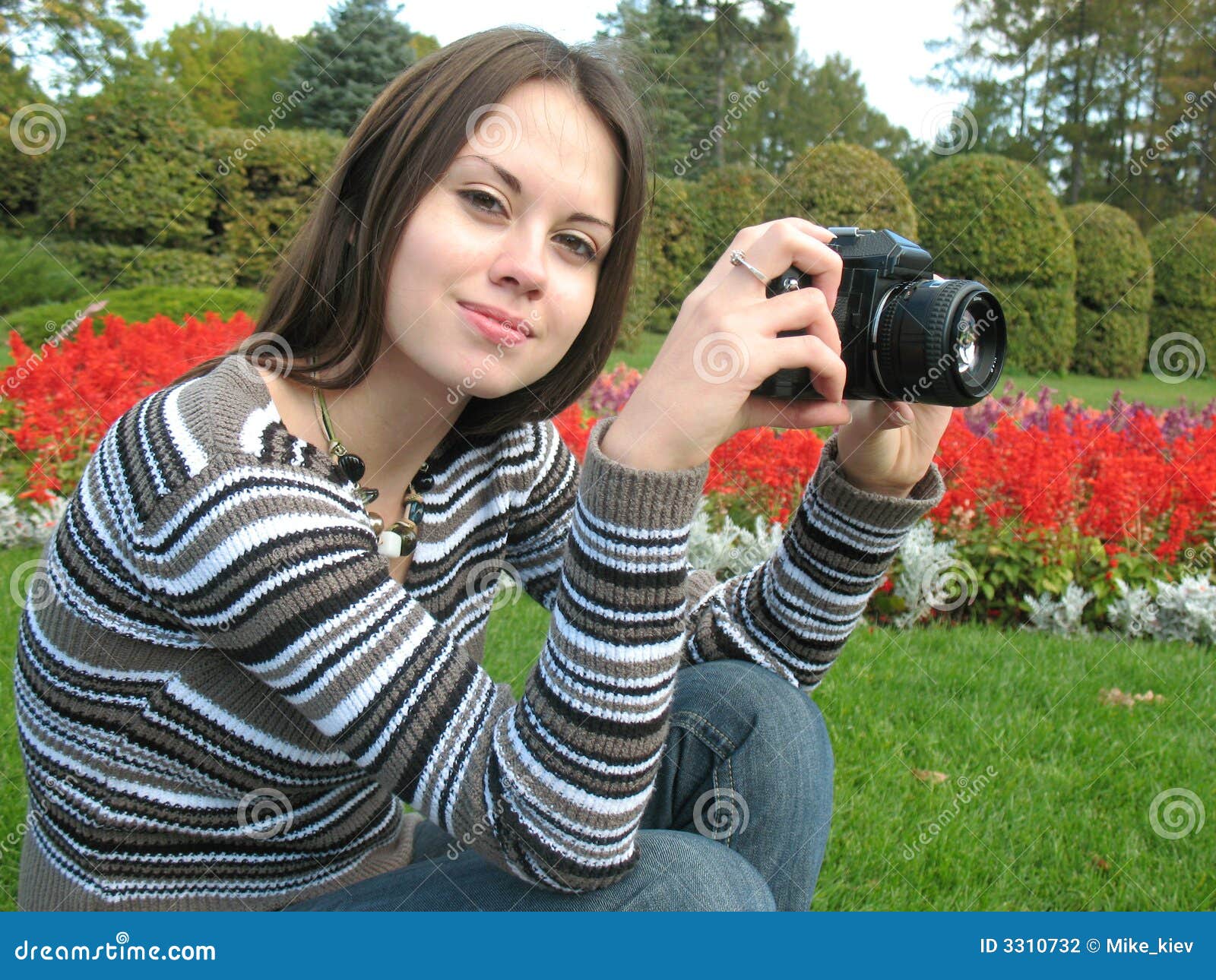 Young woman with camera stock photo. Image of grass, flowers - 3310732