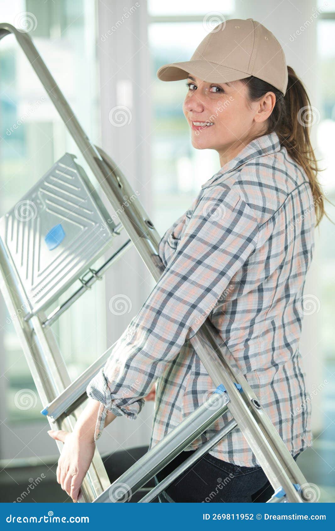 Young Woman Carrying Ladder Stock Photo - Image of industry, foreground ...