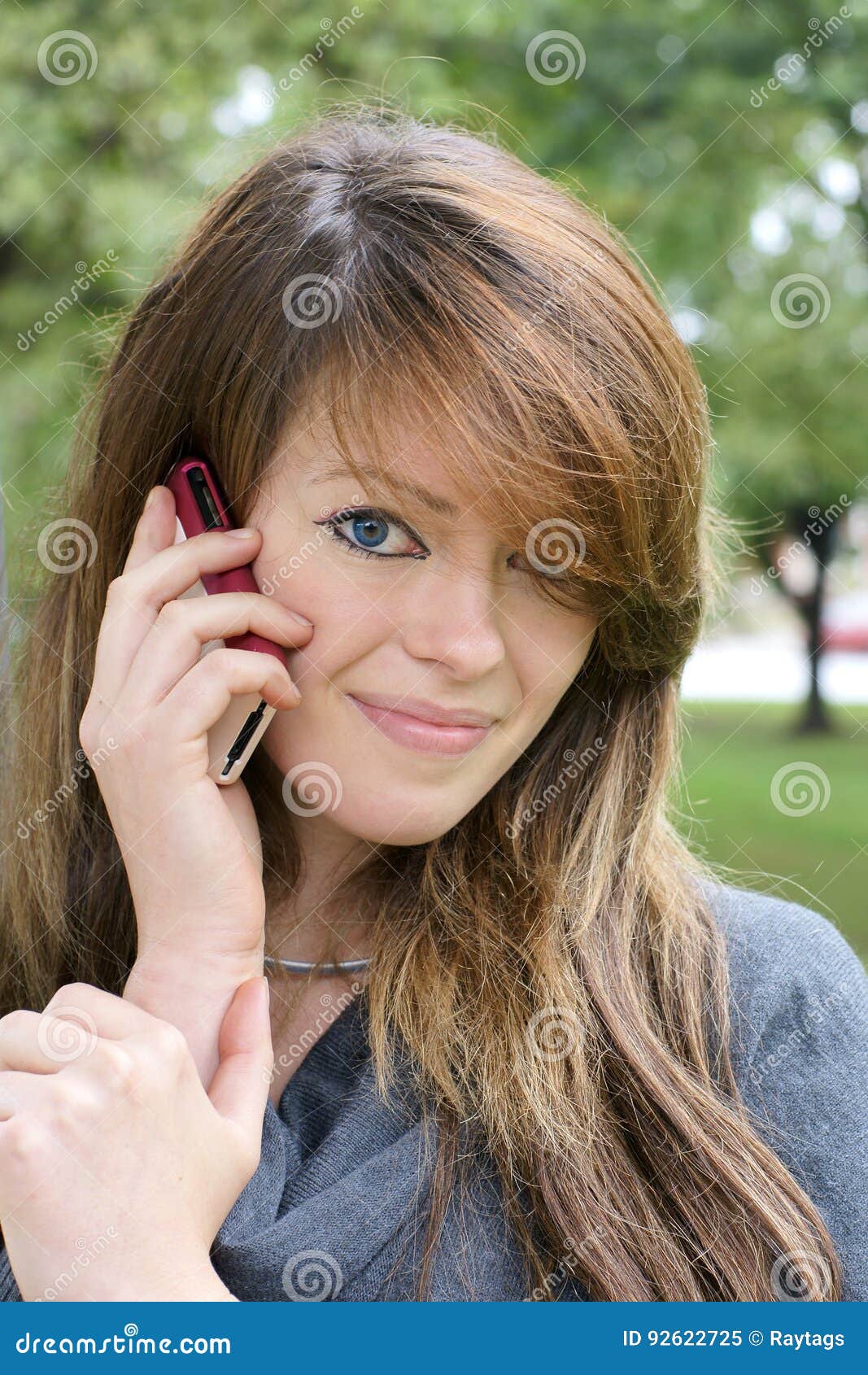 Young Woman with Cell Phone Looking at Camera Stock Image - Image of ...