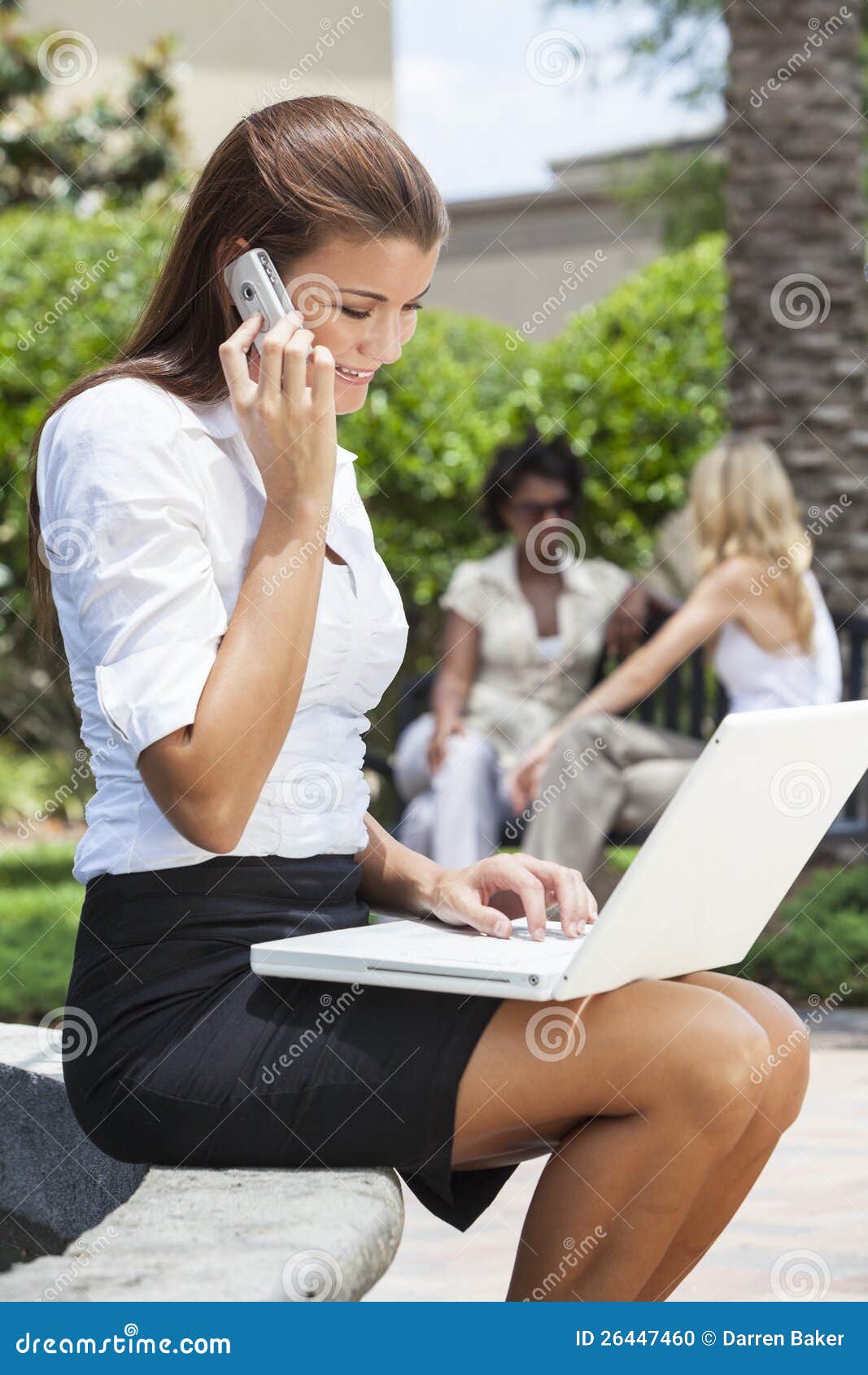 Young Woman on Cell Phone Using Laptop Computer Stock Photo - Image of ...