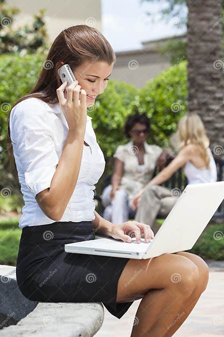 Young Woman on Cell Phone Using Laptop Computer Stock Photo - Image of ...