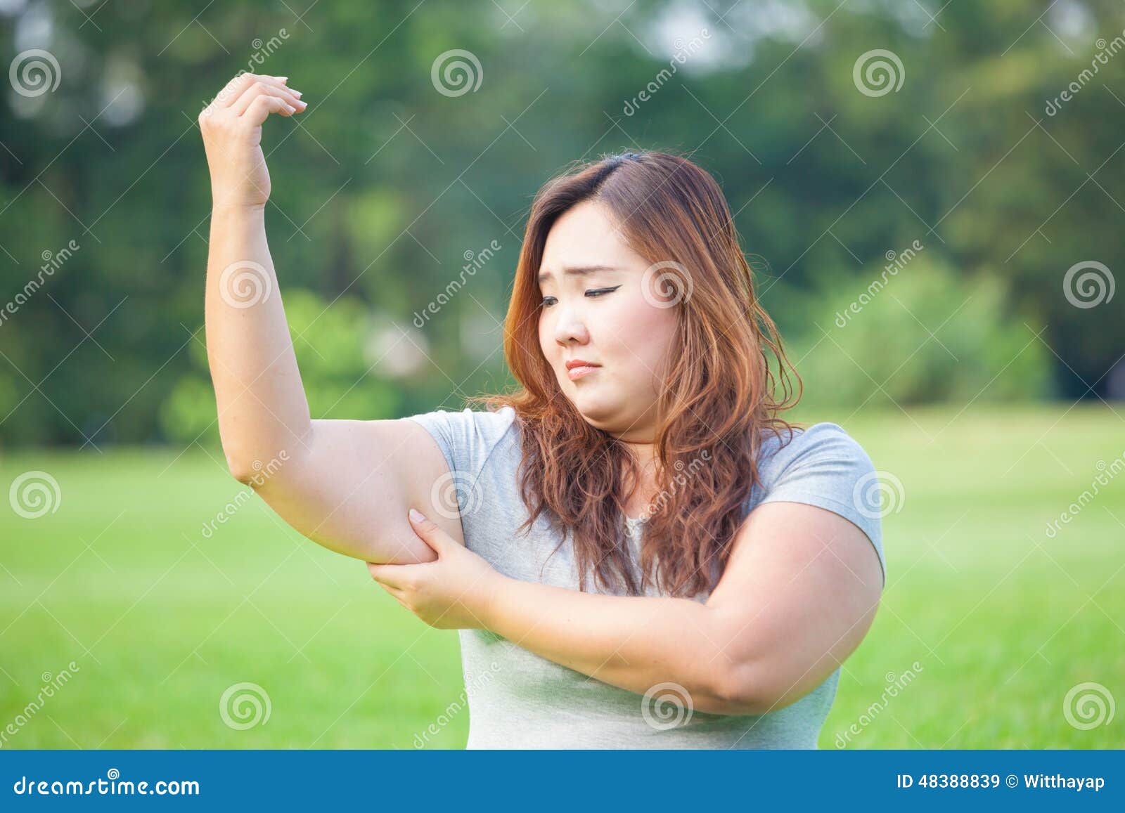 Young Woman Checking Her Arm Fat Stock Image - Image of fitness, waist ...
