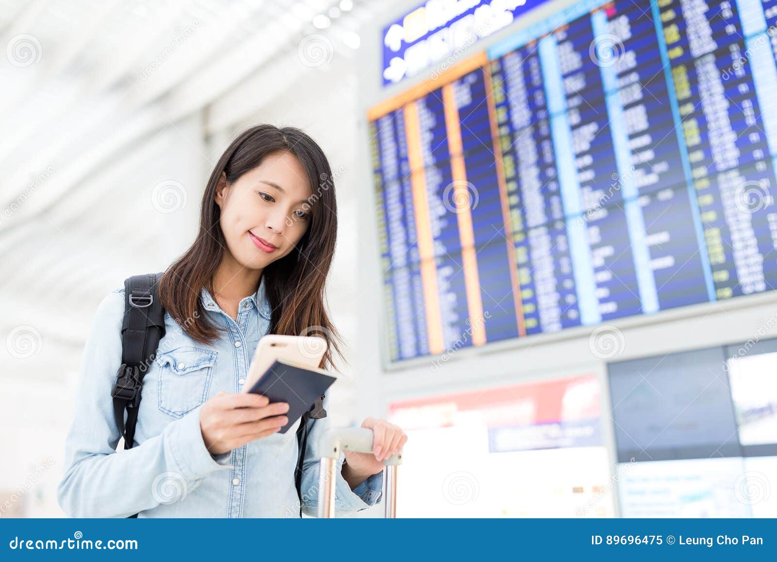 Young Woman Checking Her Flight on Cellphone Stock Image - Image of ...