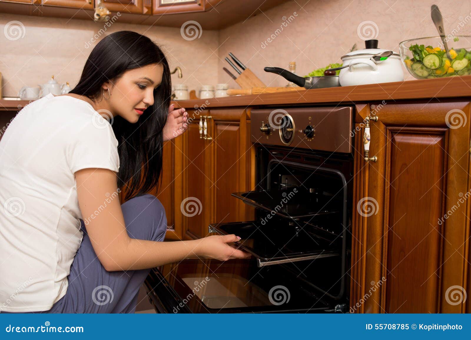 Young Woman Checking How Her Cake is Doing in the Stock Image - Image ...