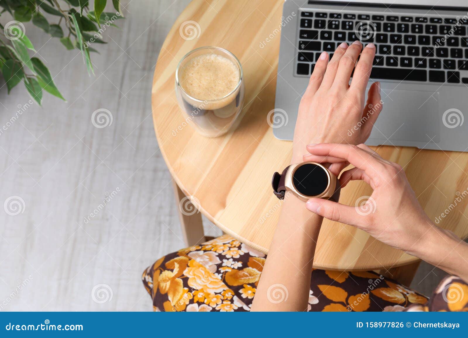 Young Woman Checking Smart Watch at Table Stock Photo - Image of ...