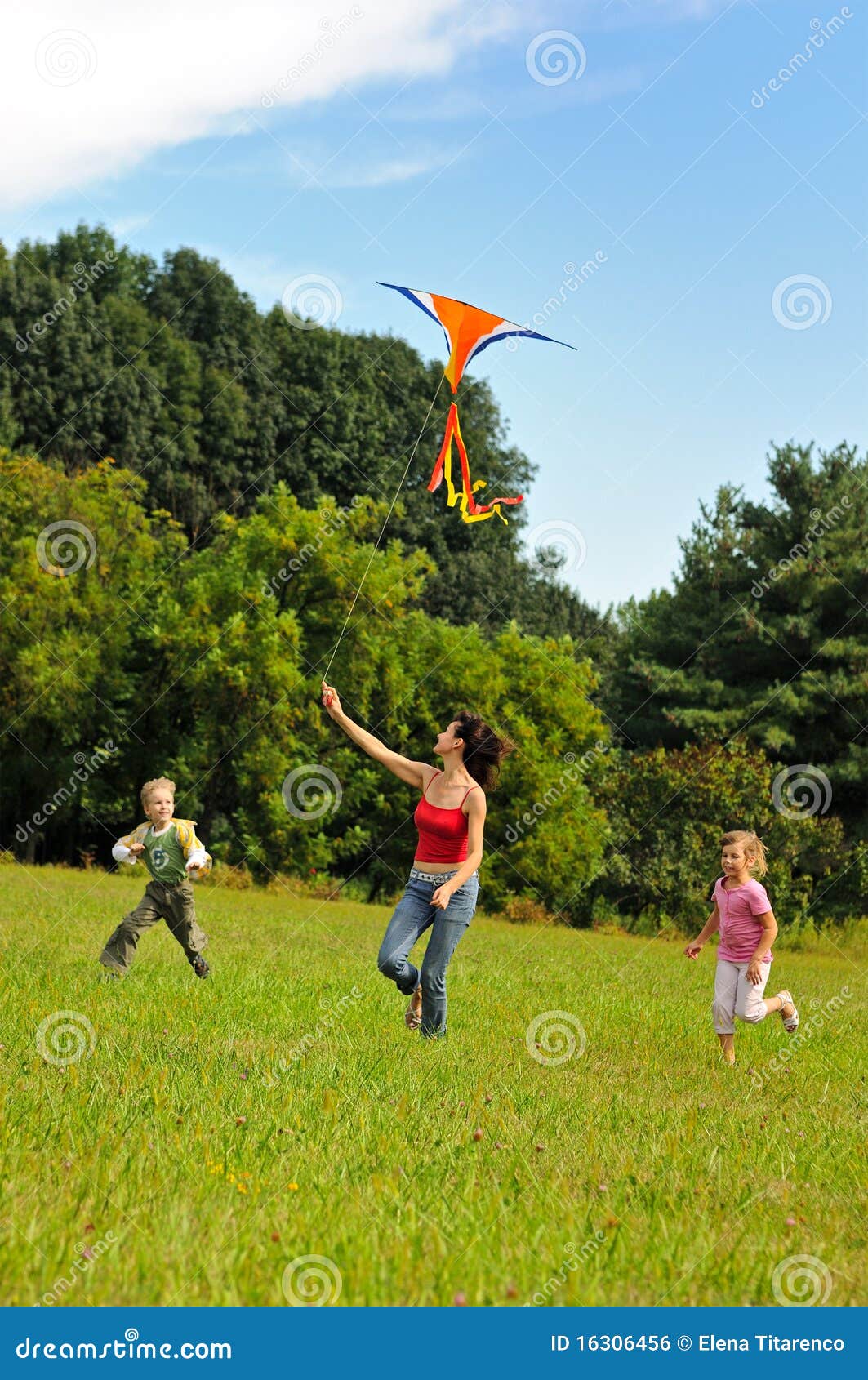 Young Woman and Children Flying a Kite Stock Photo - Image of females ...